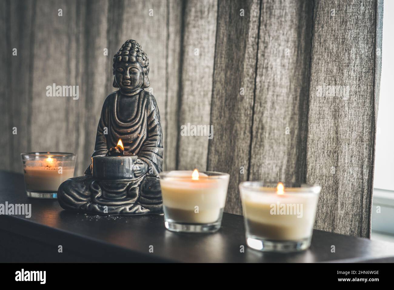 Candlestick in the shape of a buddha, smoldering Palo Santo and burning ...