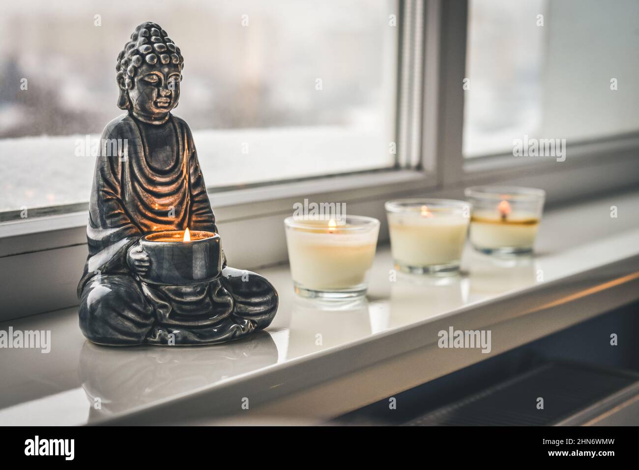 Candlestick in the shape of a buddha, smoldering Palo Santo and burning ...