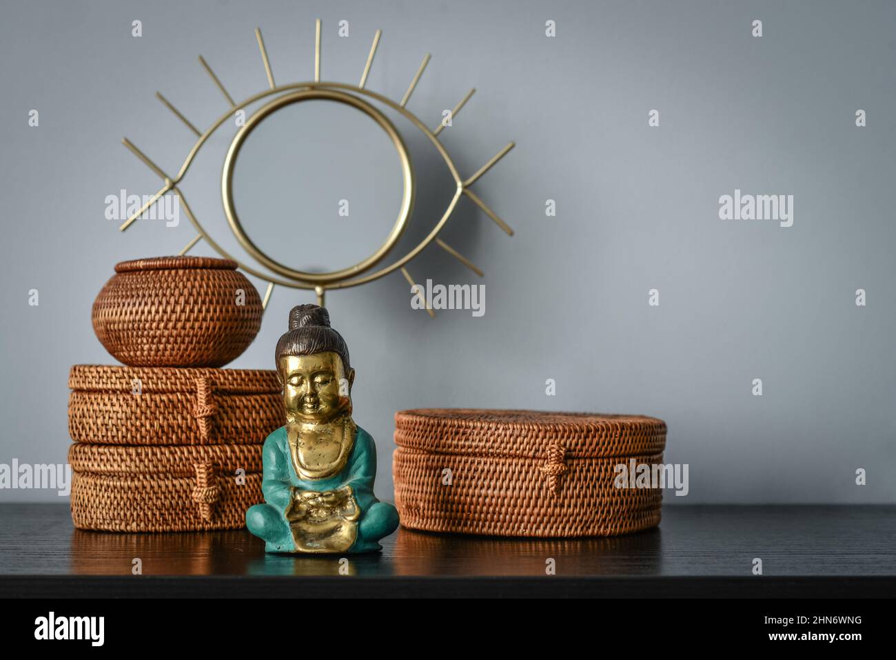 Traditional balinese woven rattan boxes, mirror and buddha statuette as ...