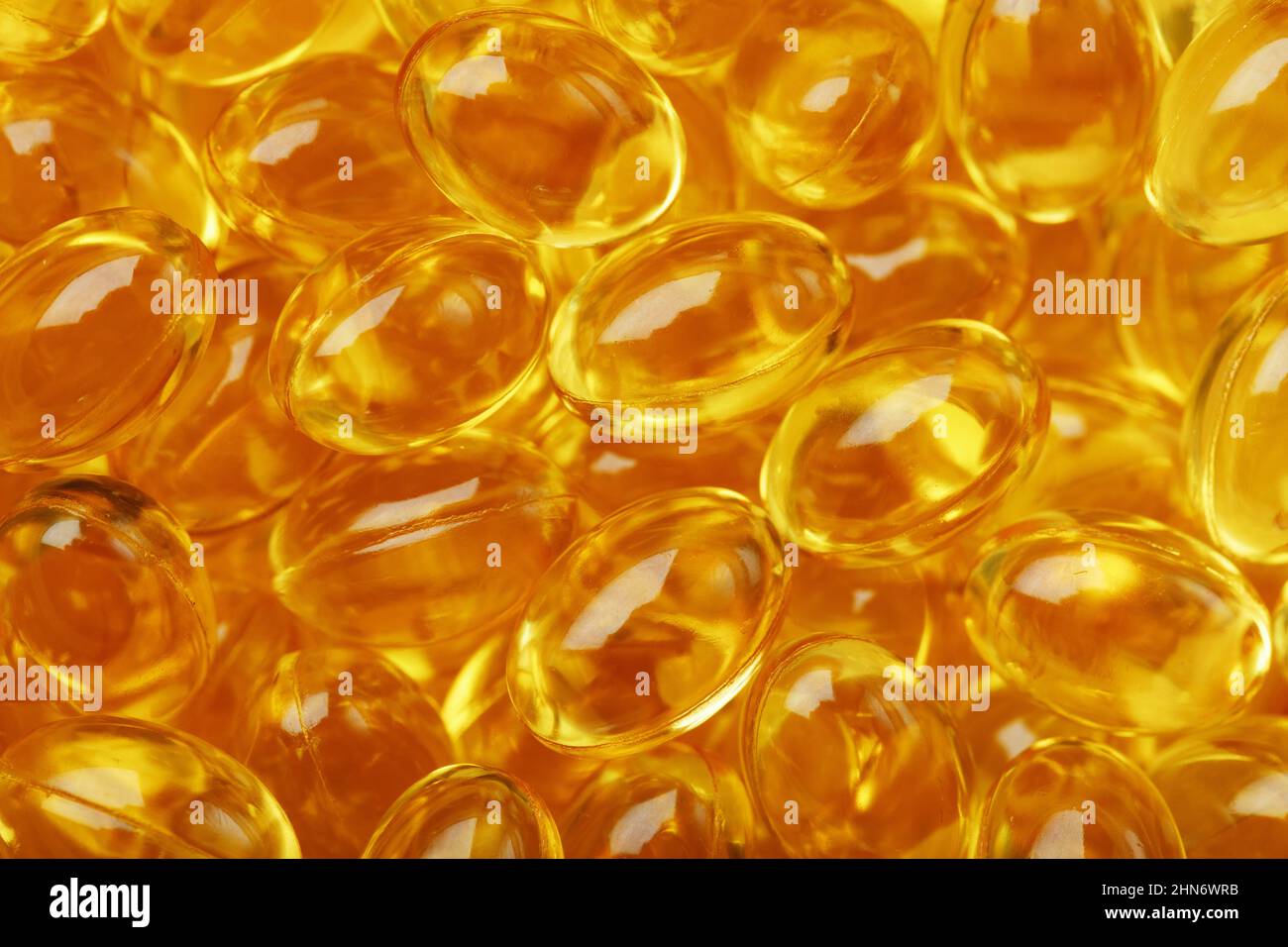 Golden capsules of Vitamin Omega 3 Fish Oil close-up in full screen ...