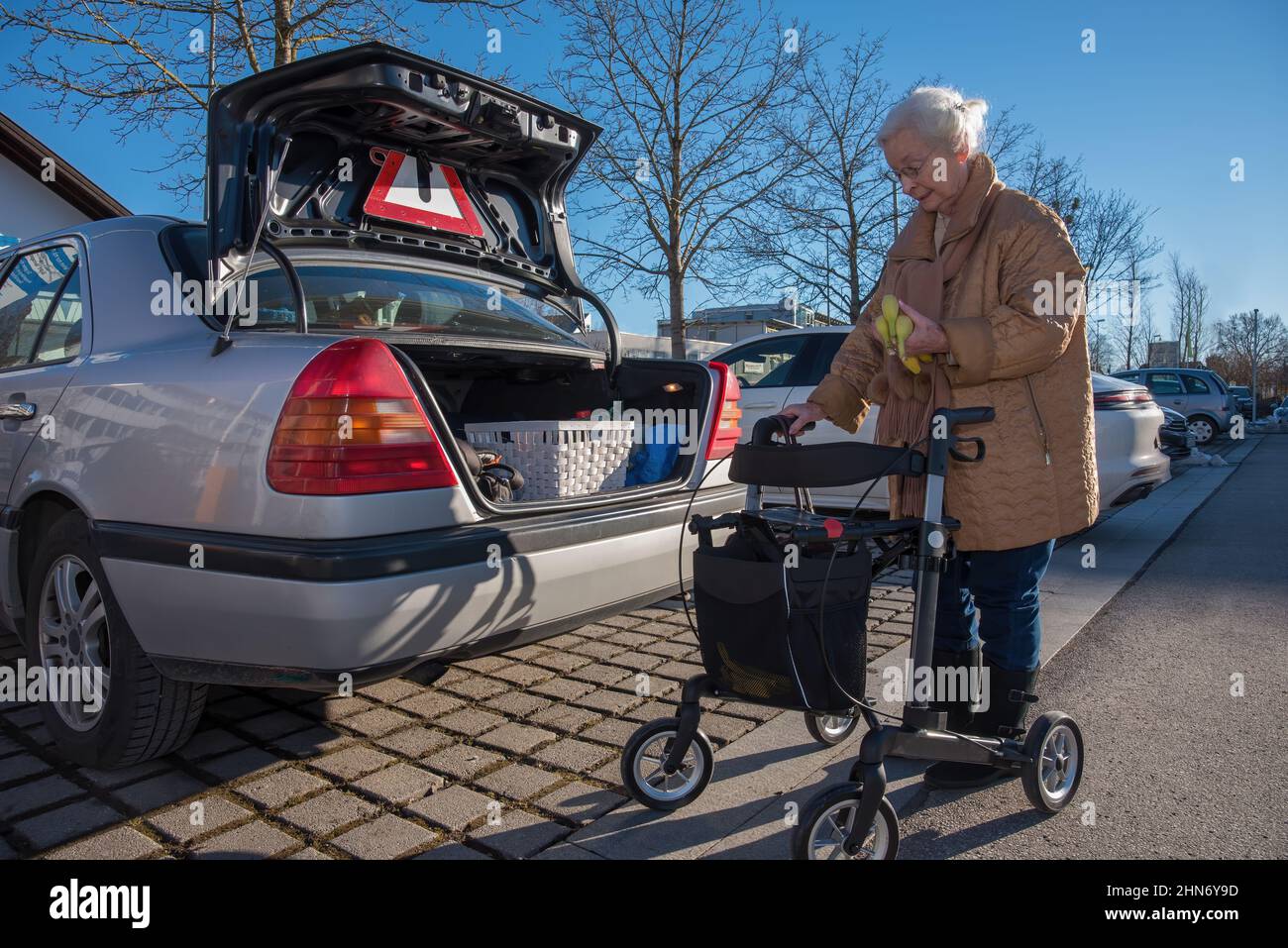 Handicapped senior woman with rollator goes shopping Stock Photo - Alamy