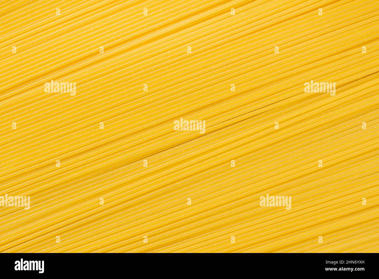 Spaghetti close-up, raw pasta, diagonal background. Italian cuisine ...