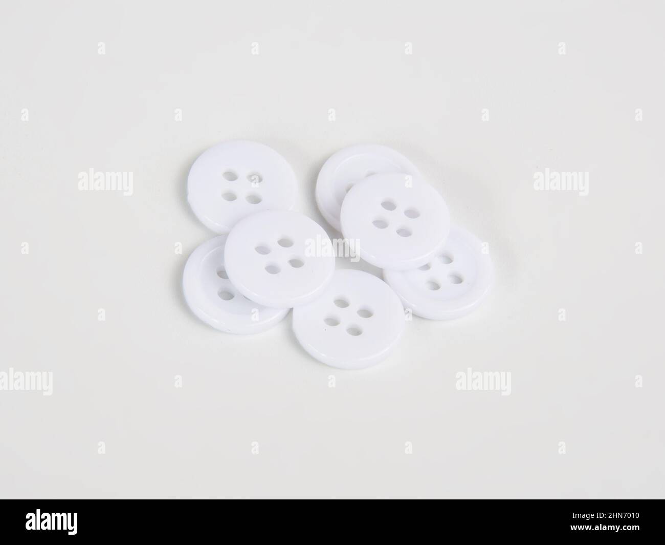 White bright cloth buttons on the white background Stock Photo - Alamy
