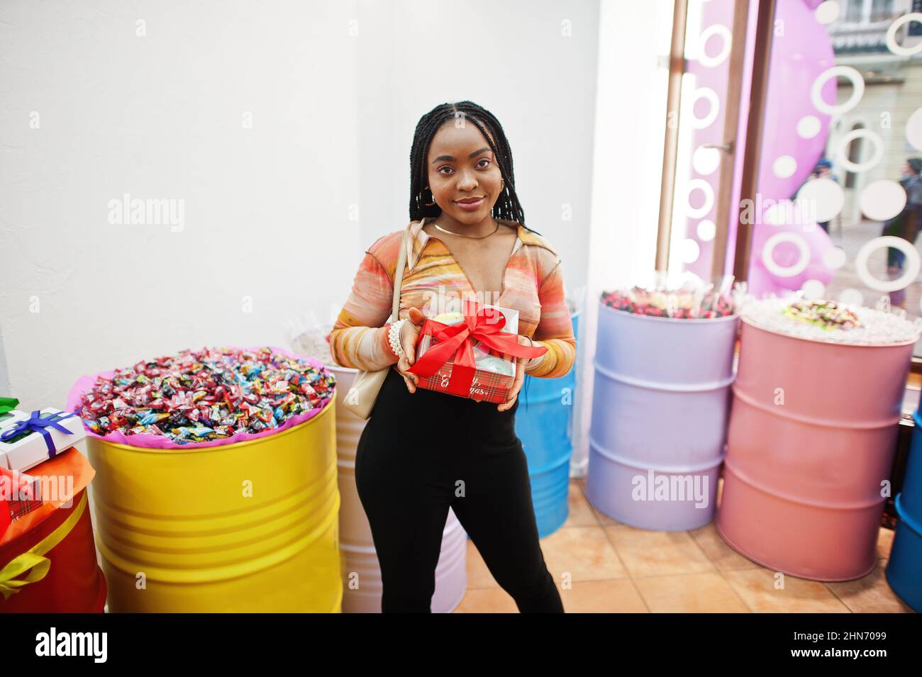 African american millennial lady at candy shop with present box of ...