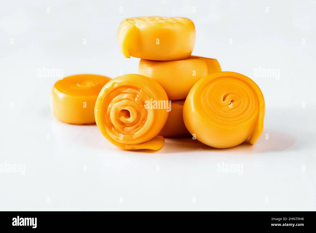 Group of twisted smoked cheese "parenica" on white background. This ...