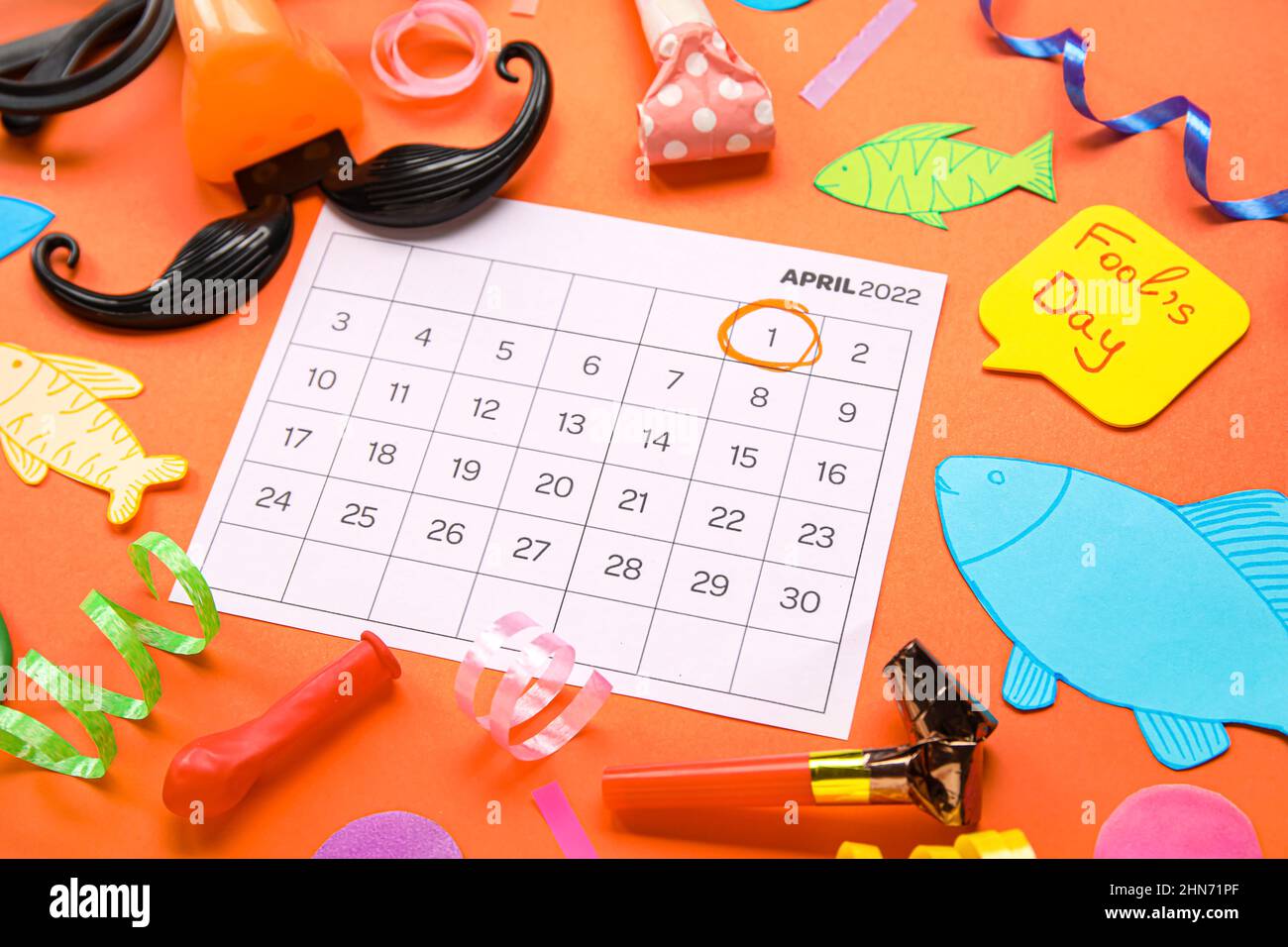 Calendar with marked date of April Fools Day and different party decor ...