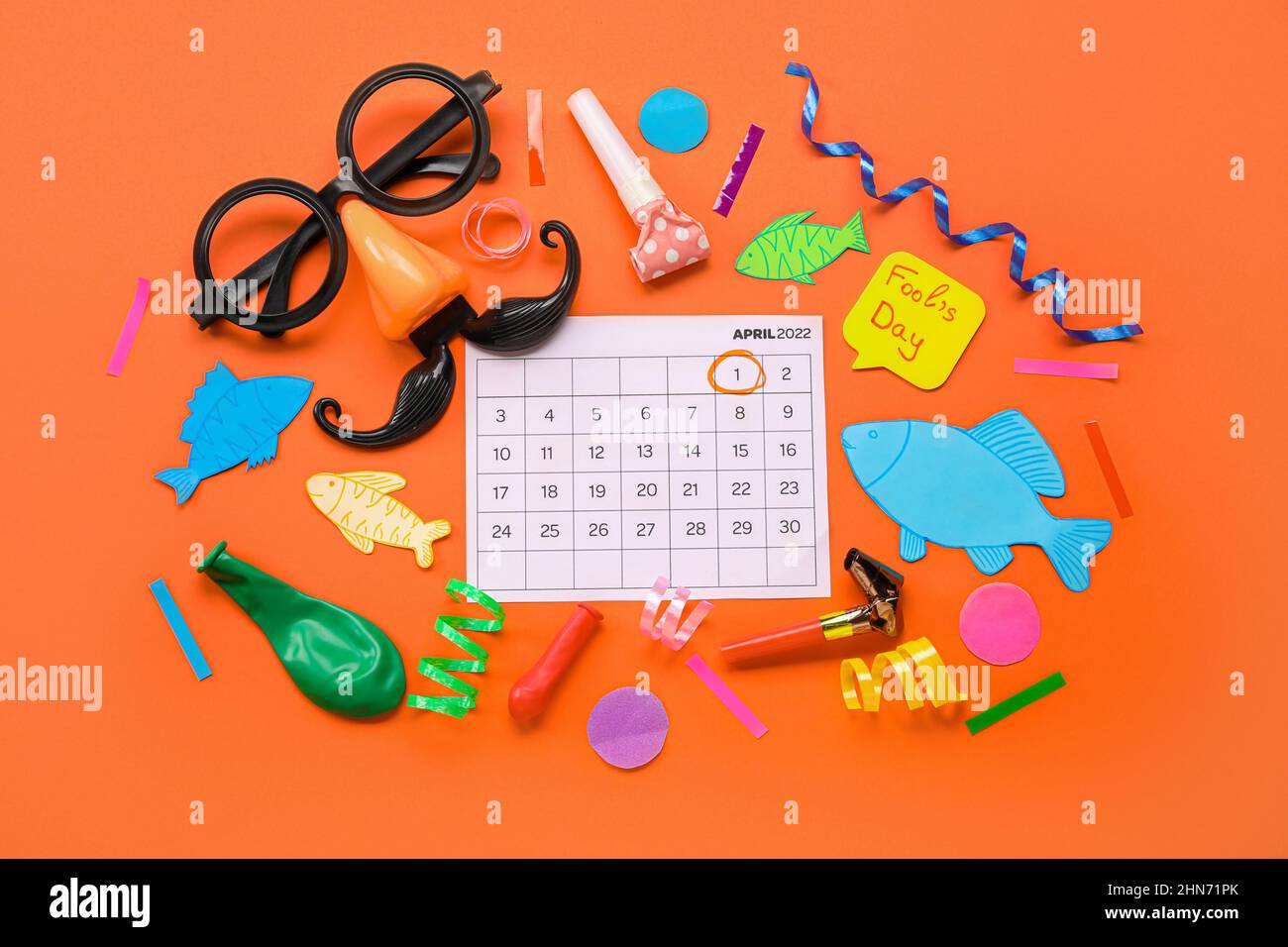 Calendar with marked date of April Fools Day and different party decor ...