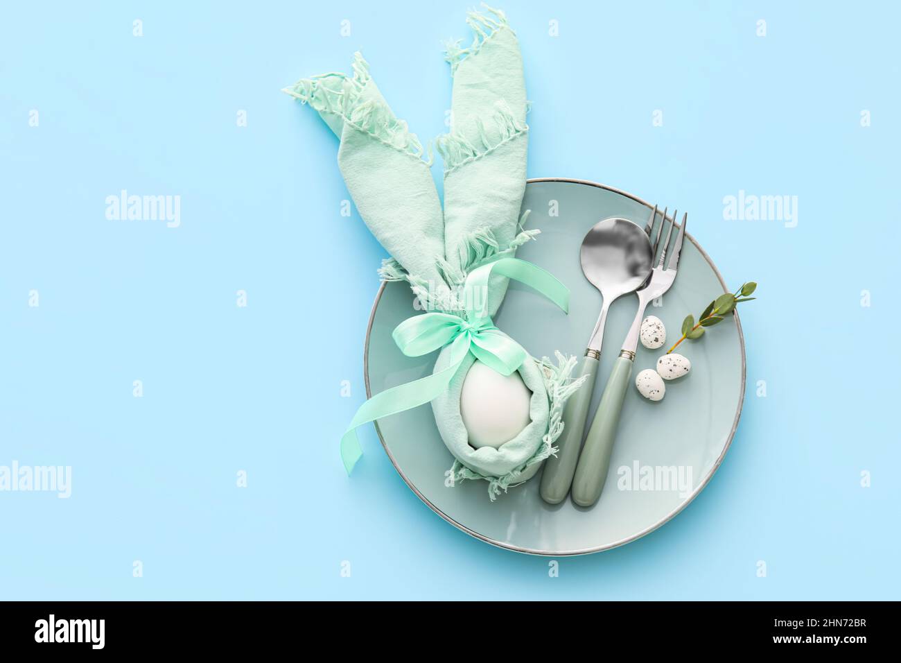 Beautiful table setting for Easter celebration on blue background Stock ...