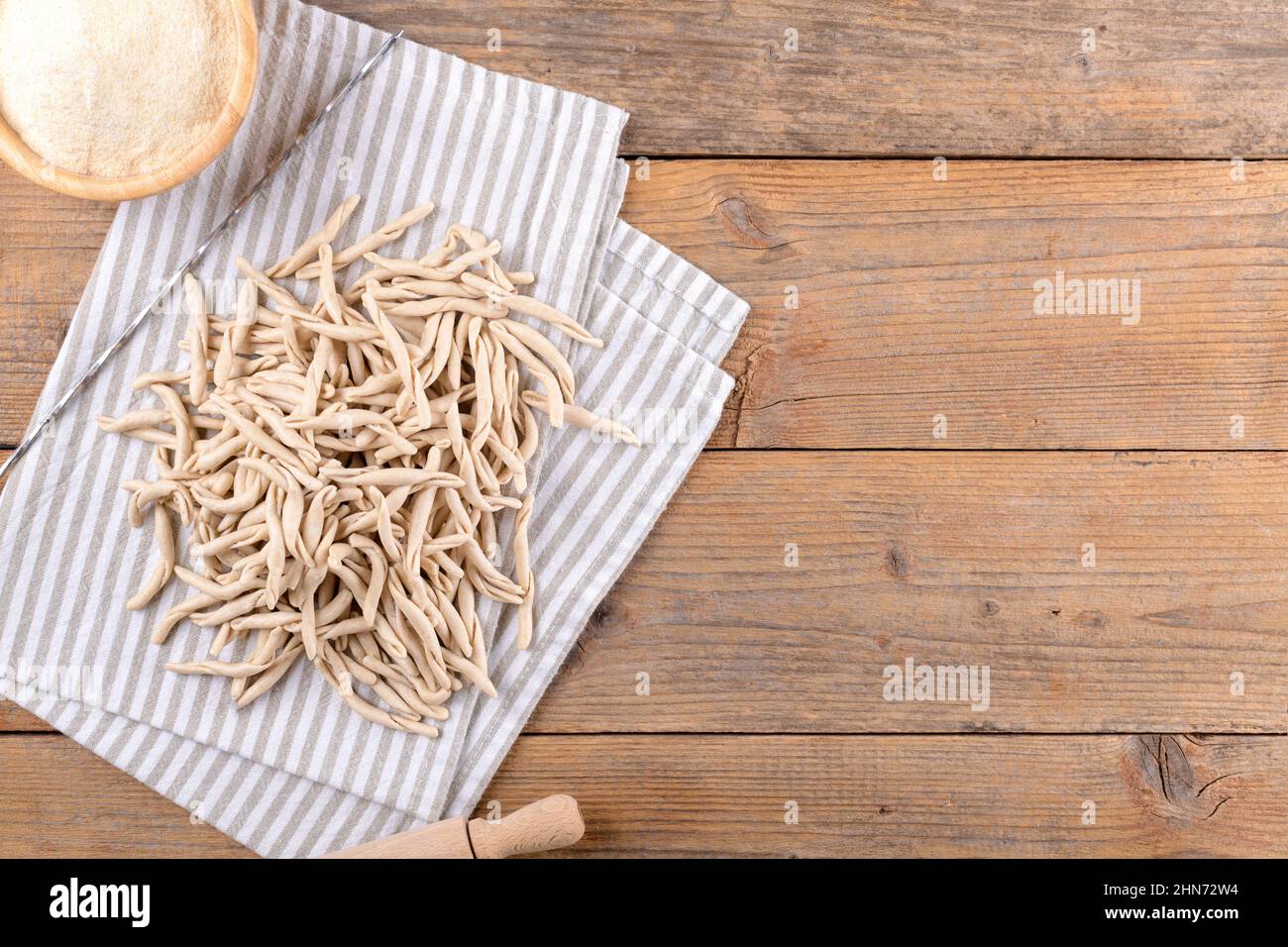 Whole grain wheat raw apulian pasta Pizzarieddi or maccaruni on a ...