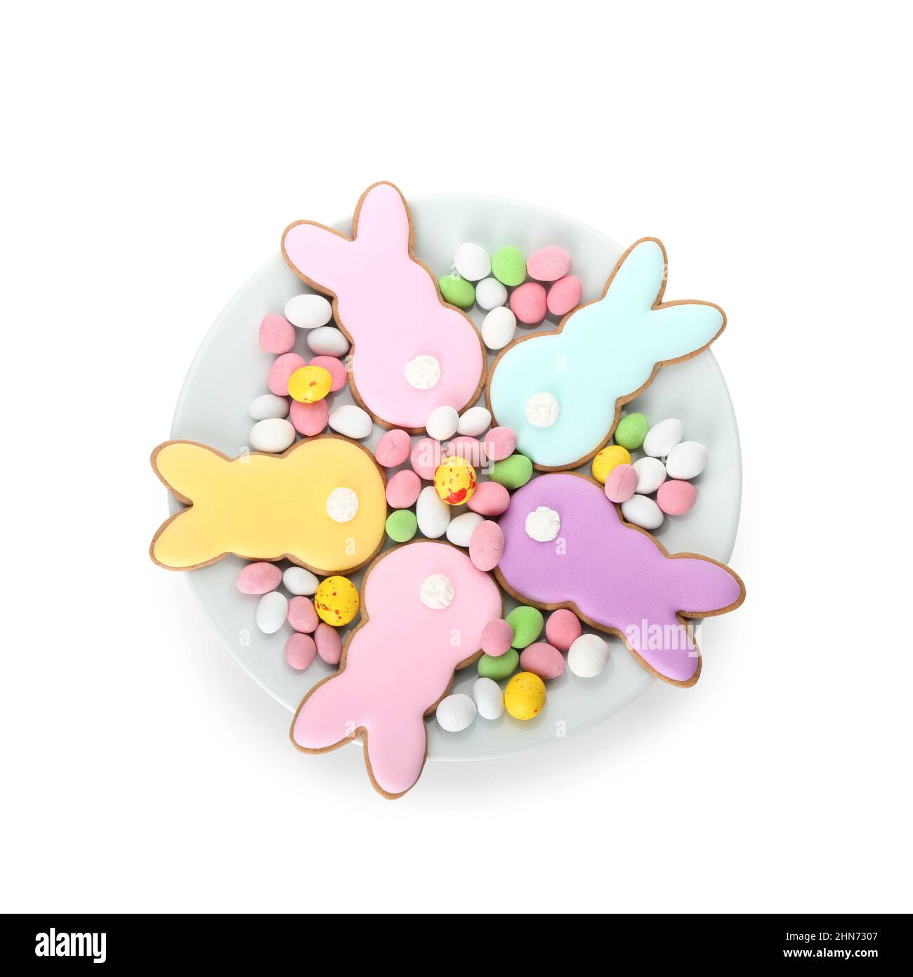 Plate with delicious Easter cookies in shape of bunny and candies on ...