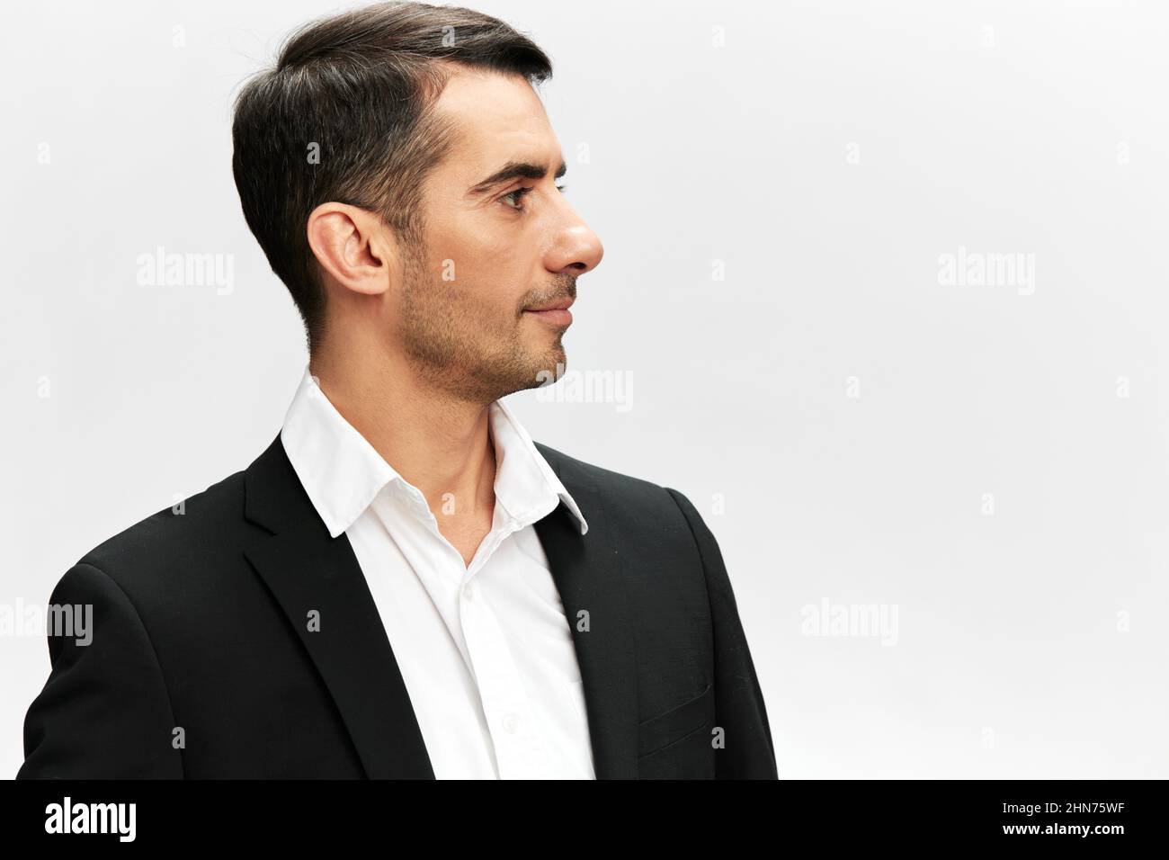 handsome man black suit side view hand gestures emotions isolated ...