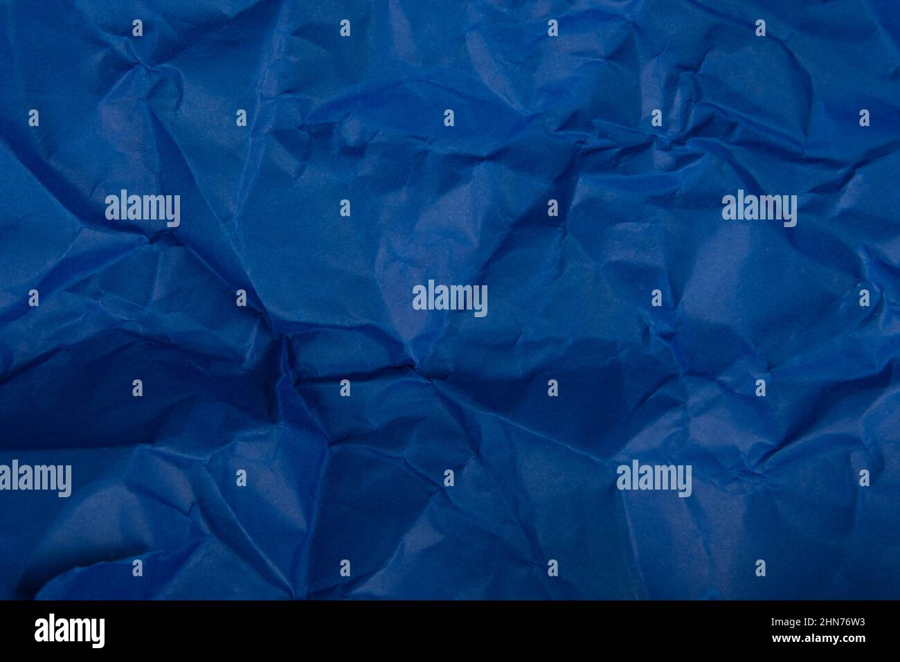 Bright crumpled paper blue color texture background Stock Photo - Alamy