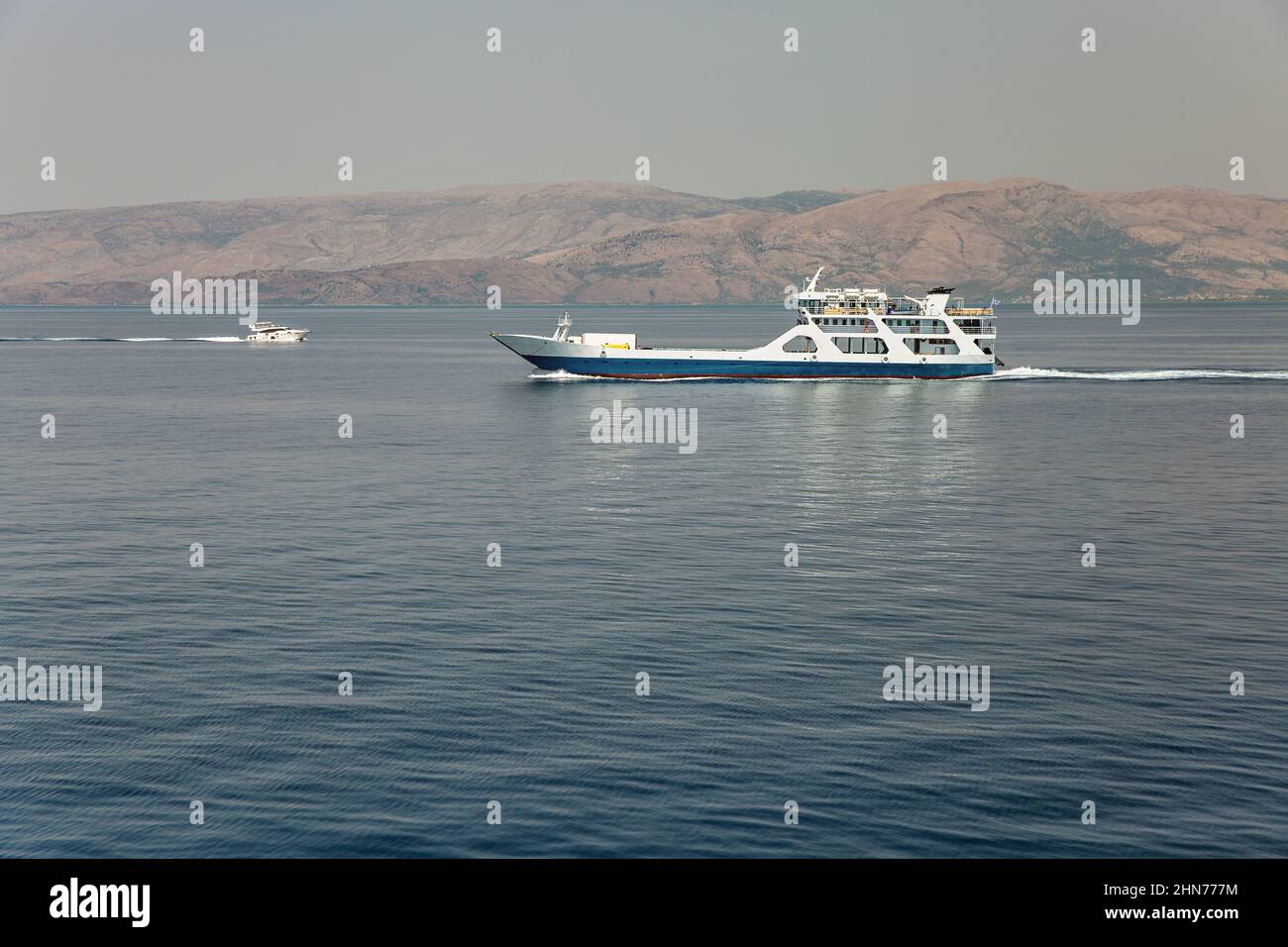 Seascape with the ferry ship sails in the distance off the coast of ...