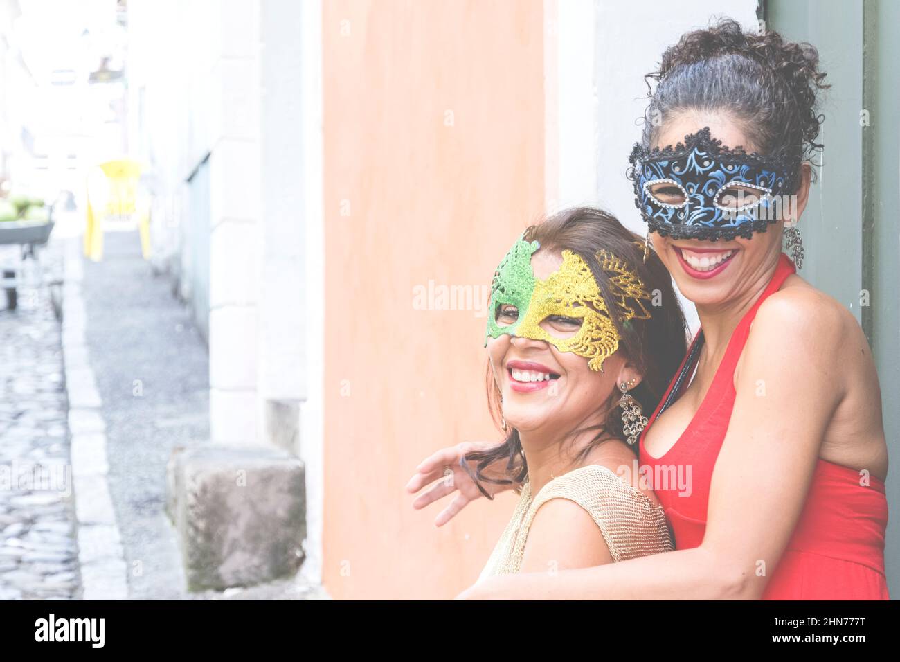 Portrait of two women wearing Venice Carnival mask. Salvador, Bahia ...