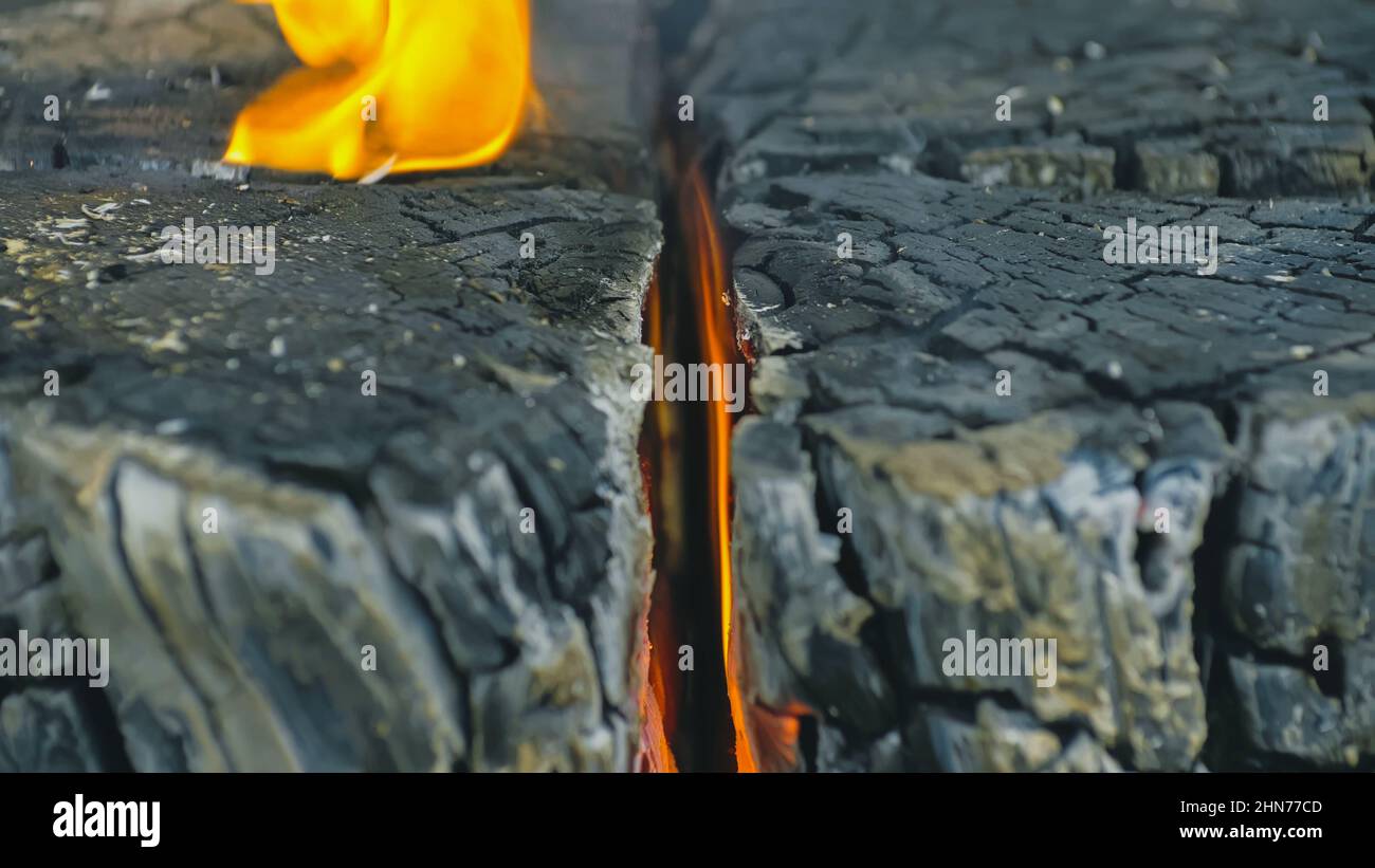 Swedish or finnish log candle. Fire burning from inside the wooden log ...