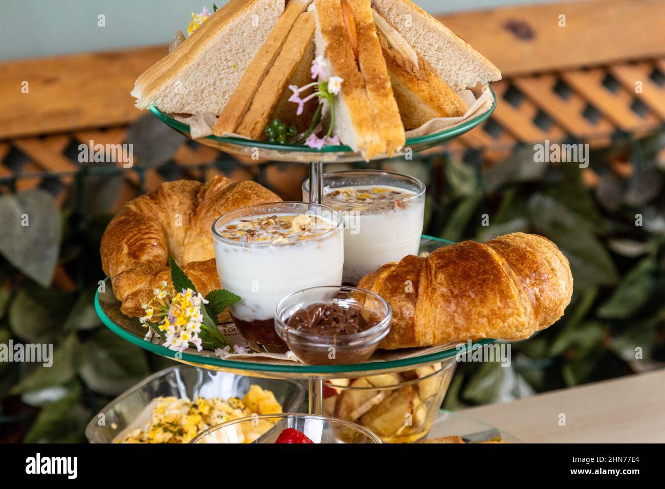 Three stage platter with dessert and sandwiches Stock Photo - Alamy