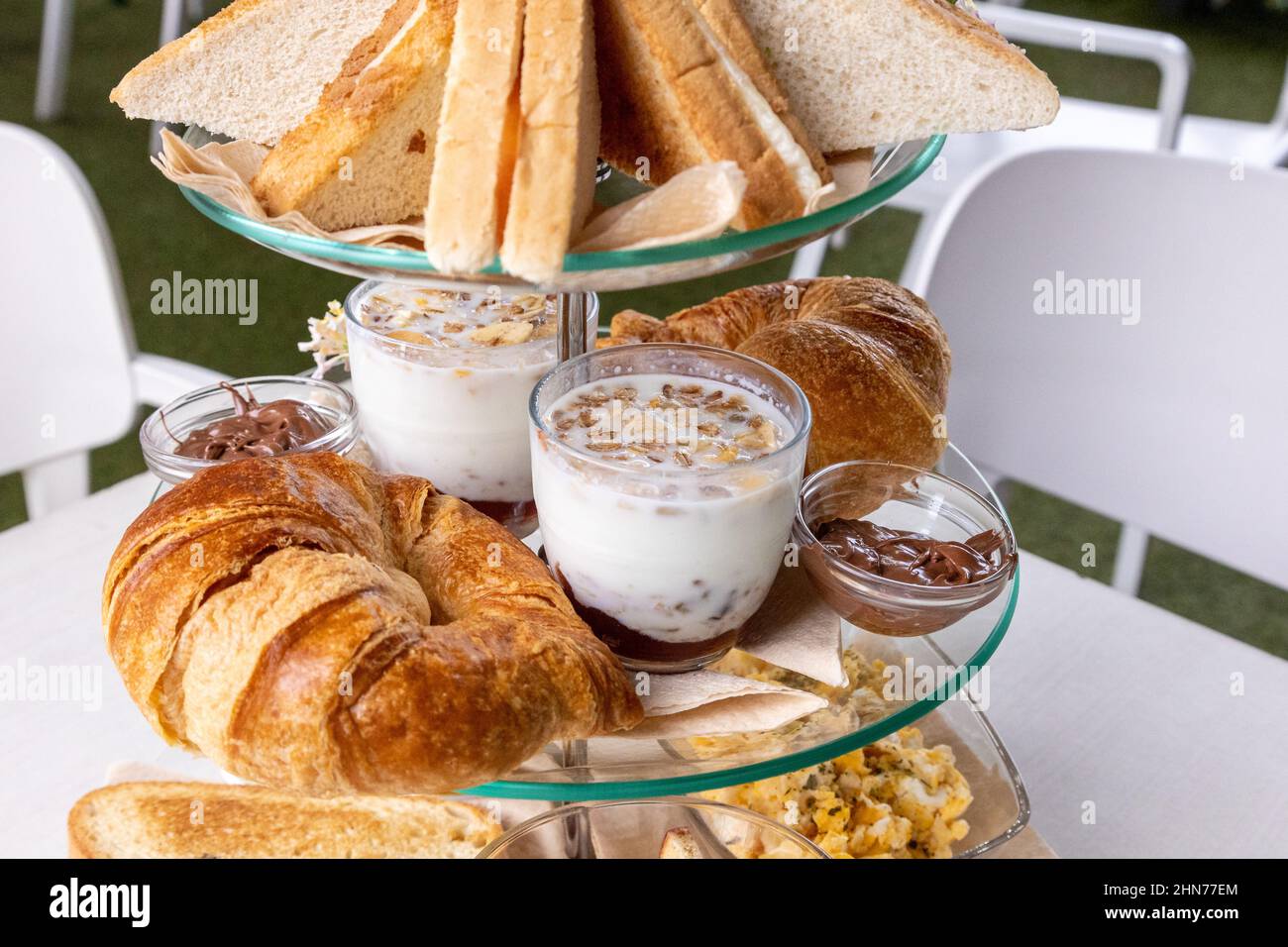 Three stage platter with dessert and sandwiches Stock Photo - Alamy