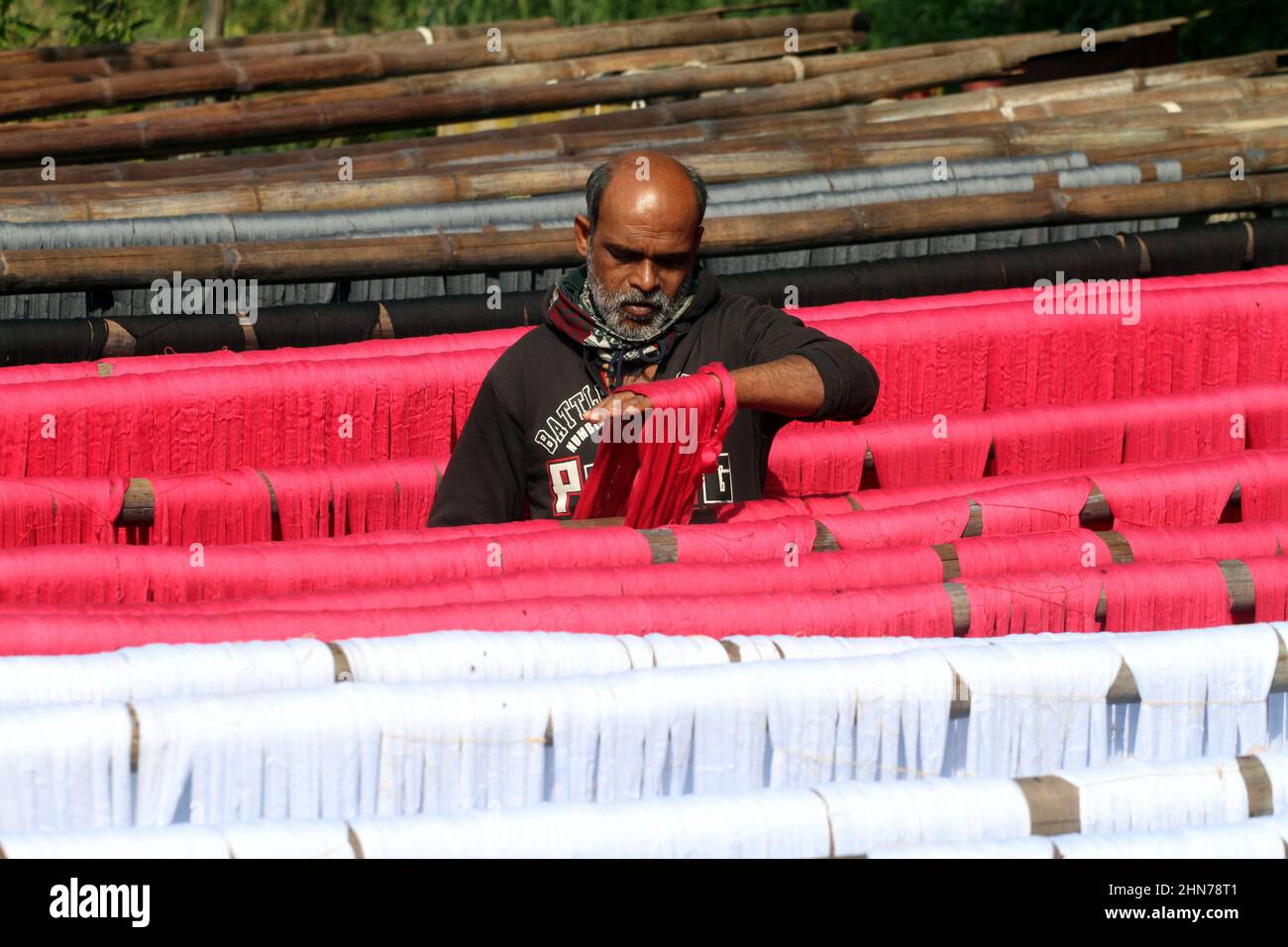 A employee work in the manufacture process of yarn to fabric production ...