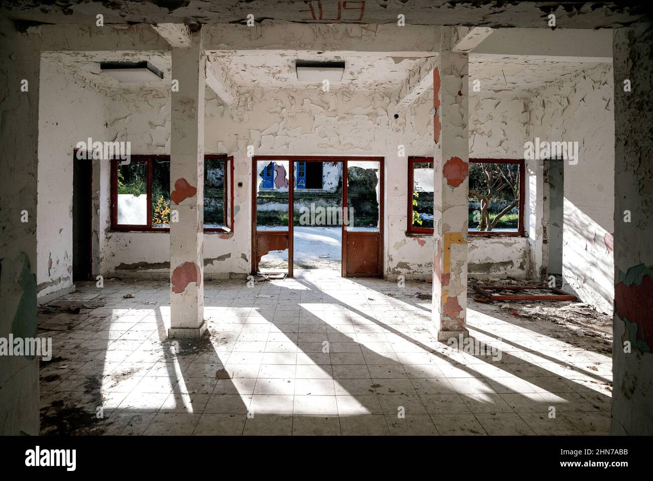 An old abandoned building with peeling plaster and broken doors and ...
