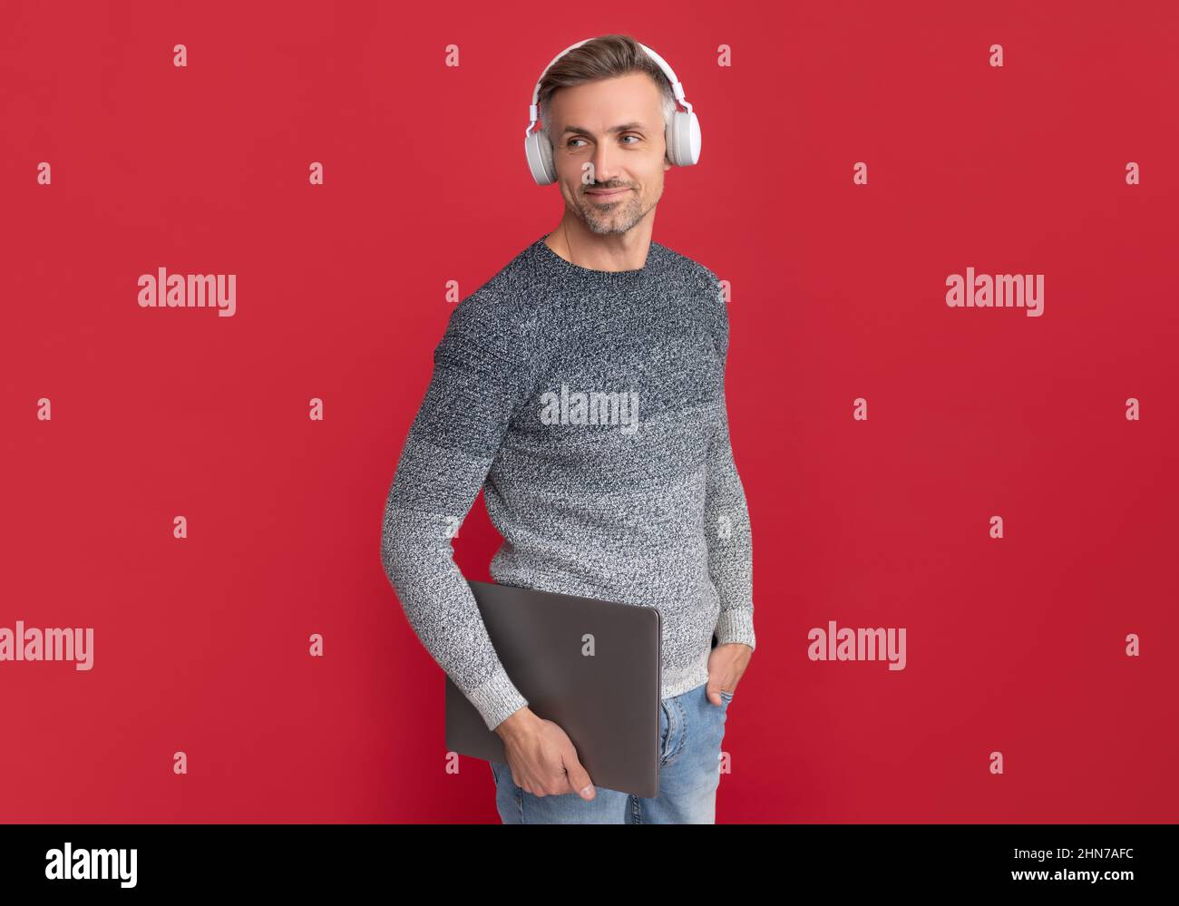 Happy guy in wear headphones for listening audio podcast on laptop red ...