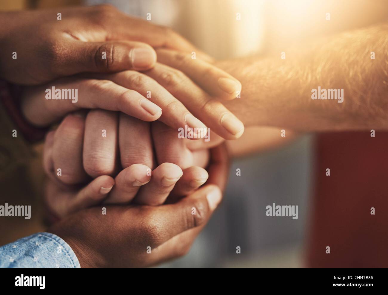 Many hands, one mind. Shot of a group of people putting their hands ...