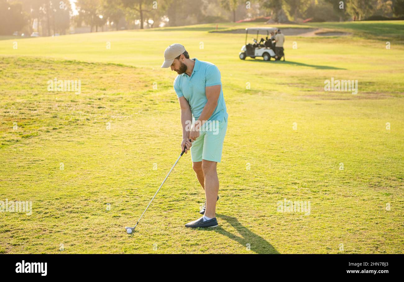 standing golfer in cap with golf club, golf swing Stock Photo - Alamy
