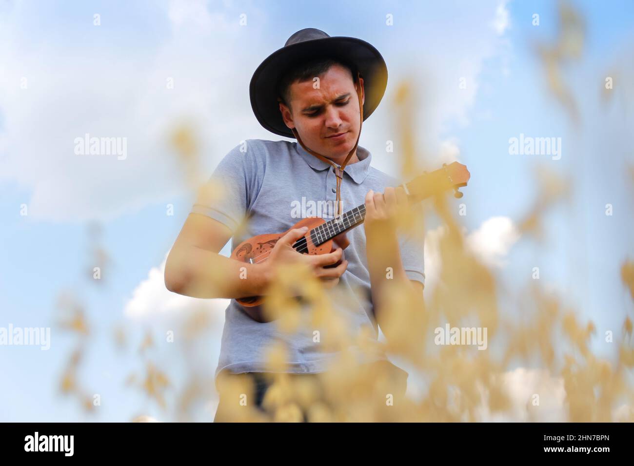 Guy playing guitar in nature hi-res stock photography and images - Alamy