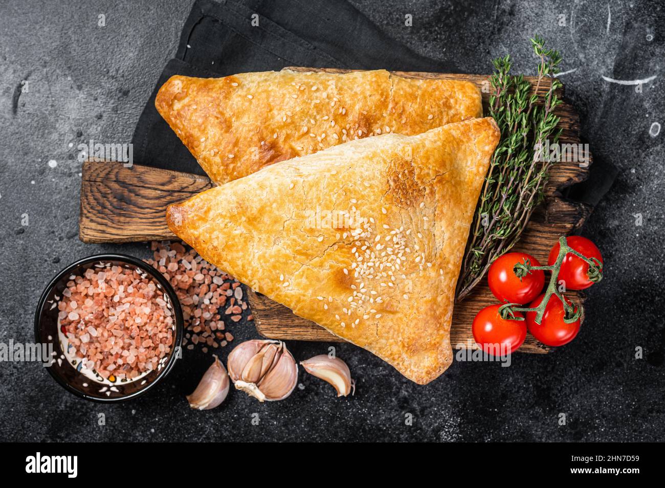 Uzbek and Central Asia samsa, samosa pies. Black background. Top view ...