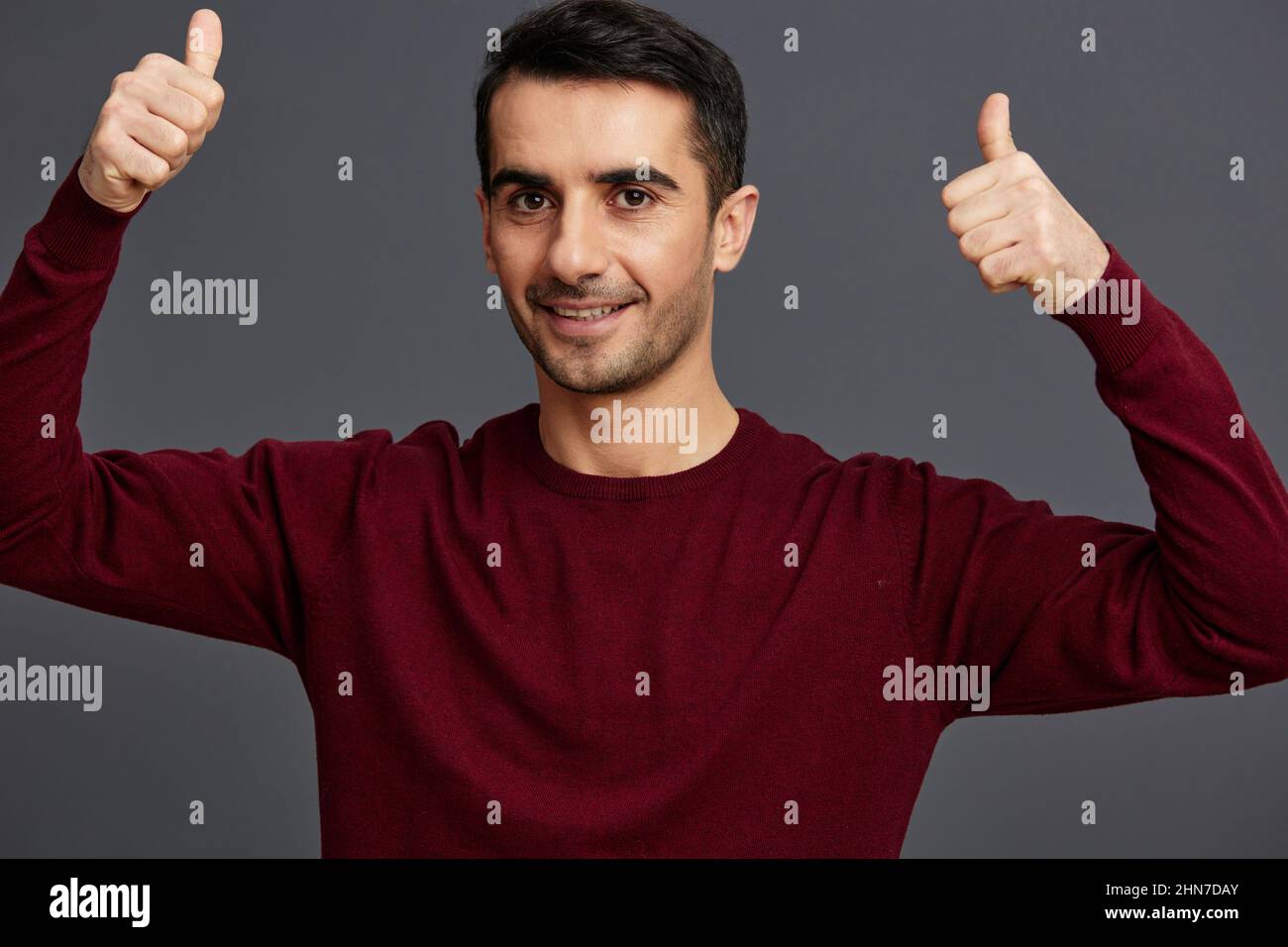portrait man posing smile gesture hands red sweater isolated background ...