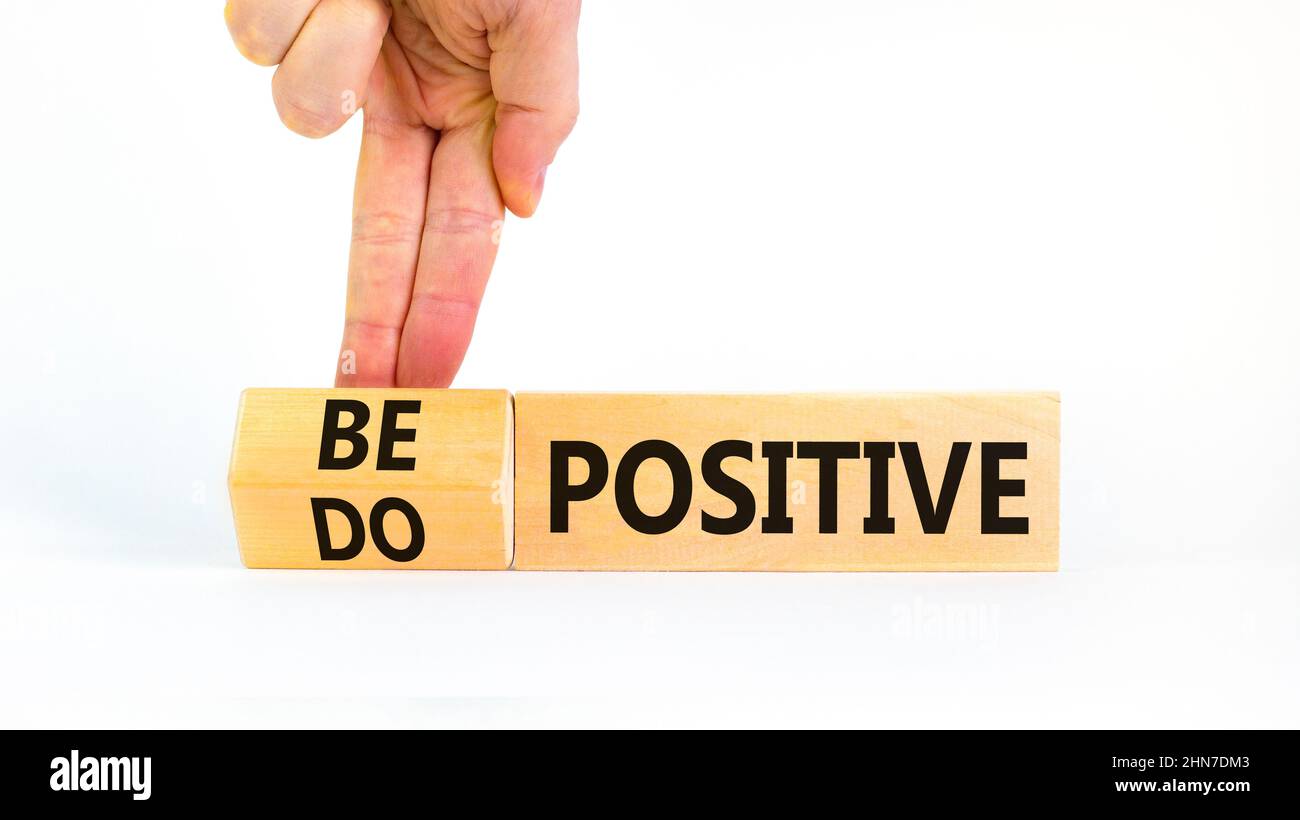 Be and do positive symbol. Businessman turns wooden cubes and changes ...