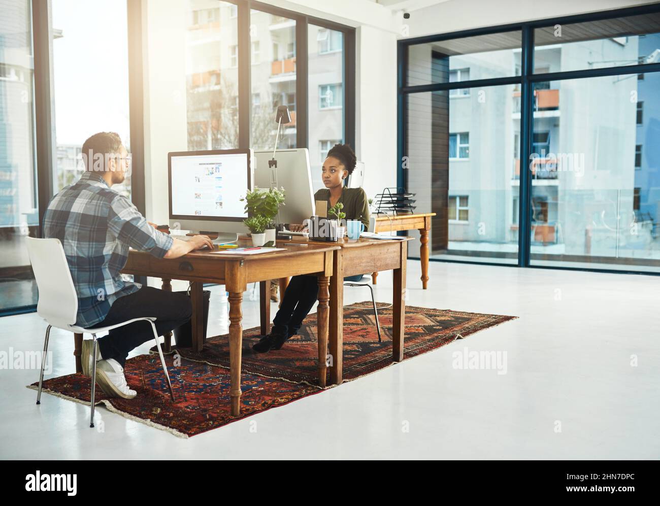 Working opposite a colleague. Full length shot of two businesspeople ...