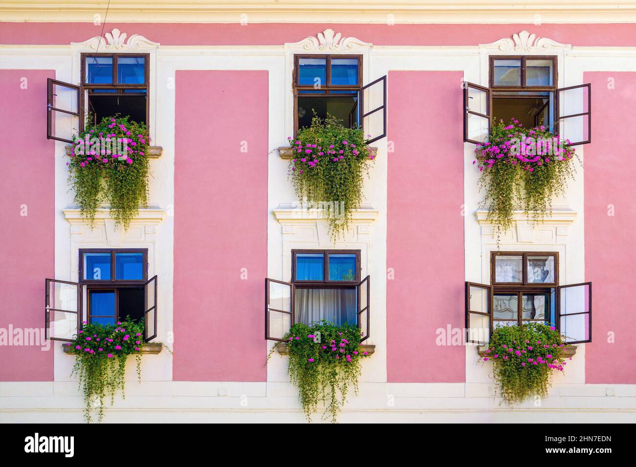 A beautiful residential building with open shuttered windows. European ...