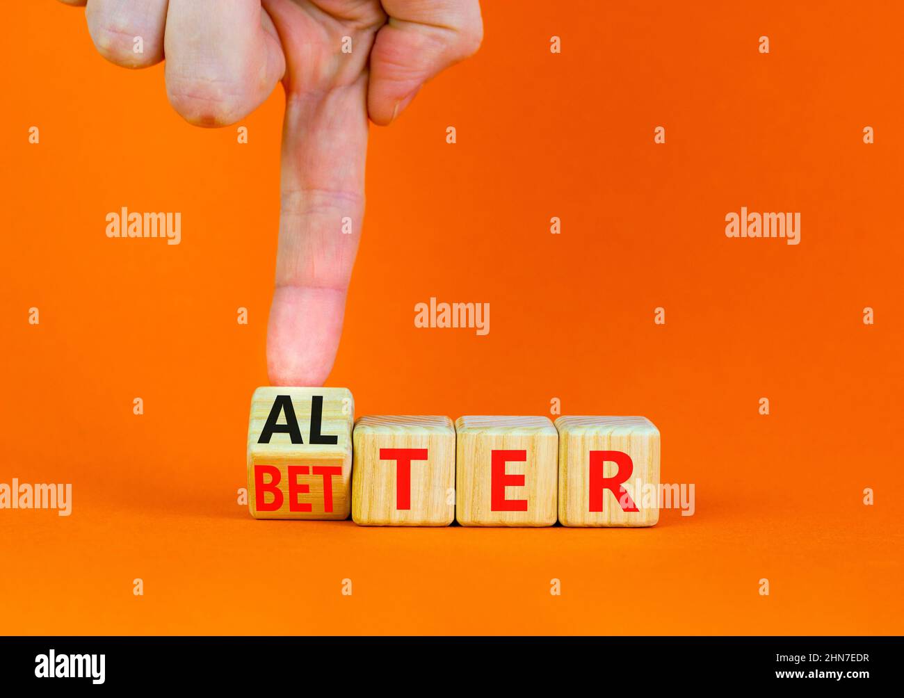 Alter or better symbol. Businessman turns wooden cubes and changes the ...