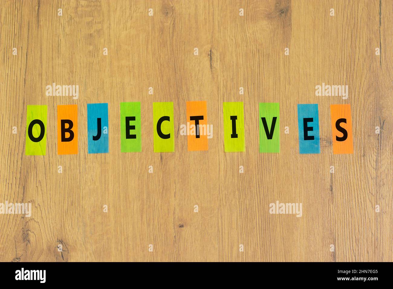 Objectives symbol. The concept word Objectives on colored papers on a ...