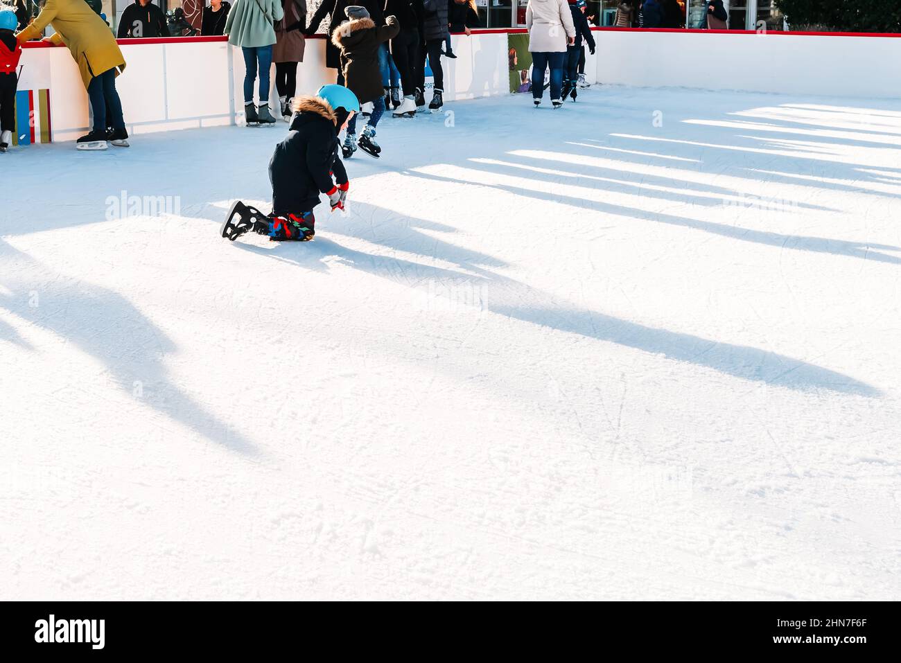 Soft,Selective focus. child fell on the rink while skating.Adorable ...