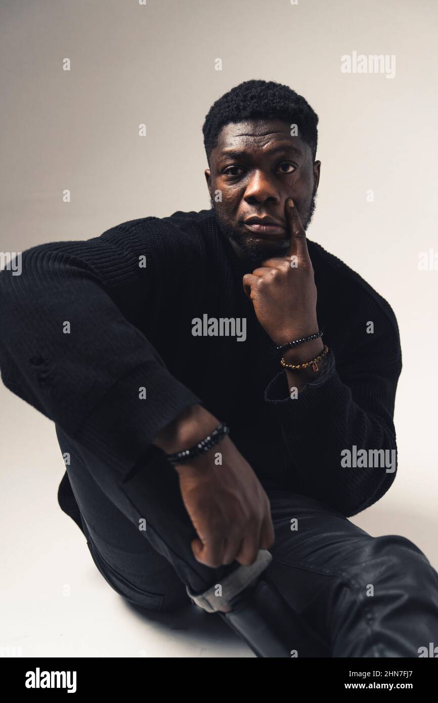 eyelid pull gesture on an African American guy sitting - portrait shot ...