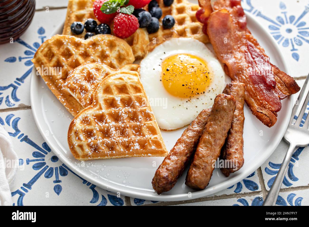 Breakfast table with waffles. fried egg, bacon and sausage Stock Photo ...