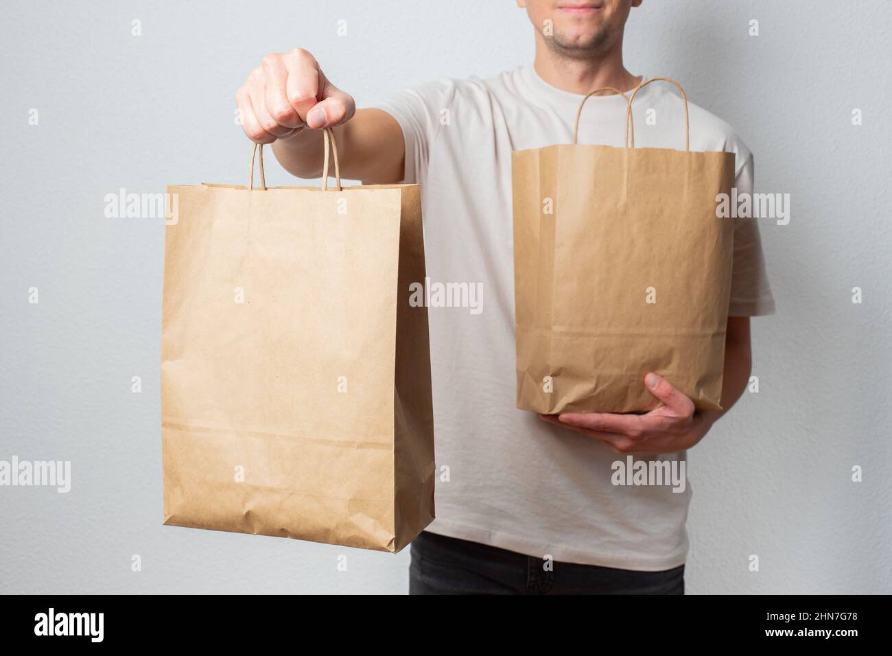 Delivery Concept - Handsome Caucasian delivery man carrying package bag ...