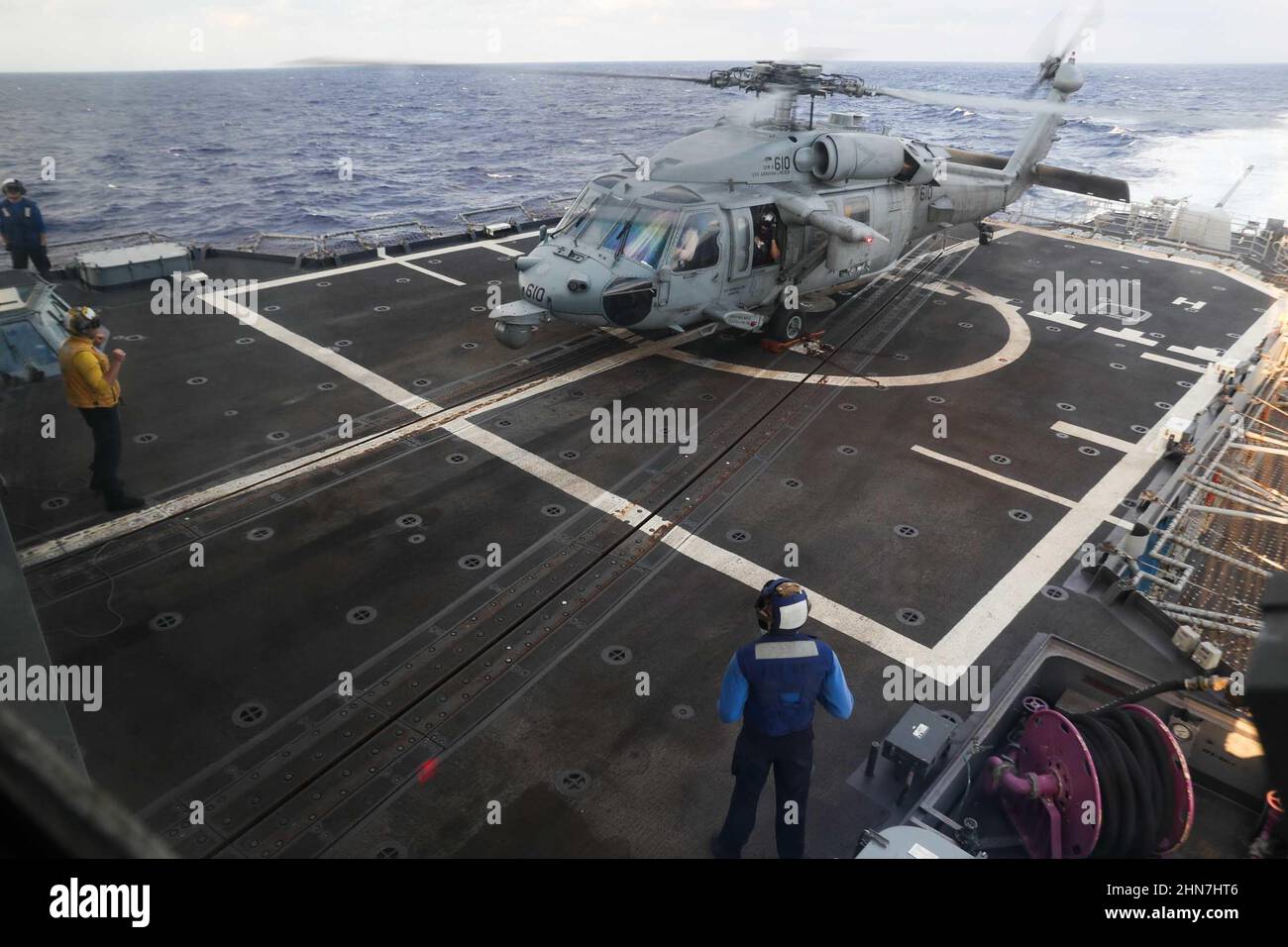 PHILIPPINE SEA (Feb. 12, 2022) Sailors prepare for an MH-60R Sea hawk ...