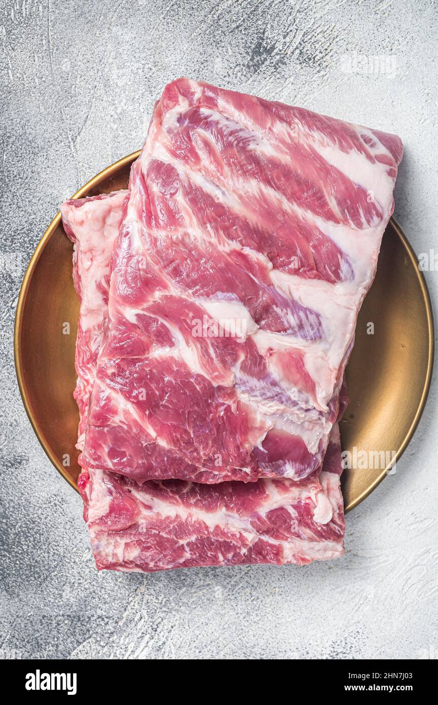 Rack of raw pork spare ribs. White background. Top view Stock Photo - Alamy