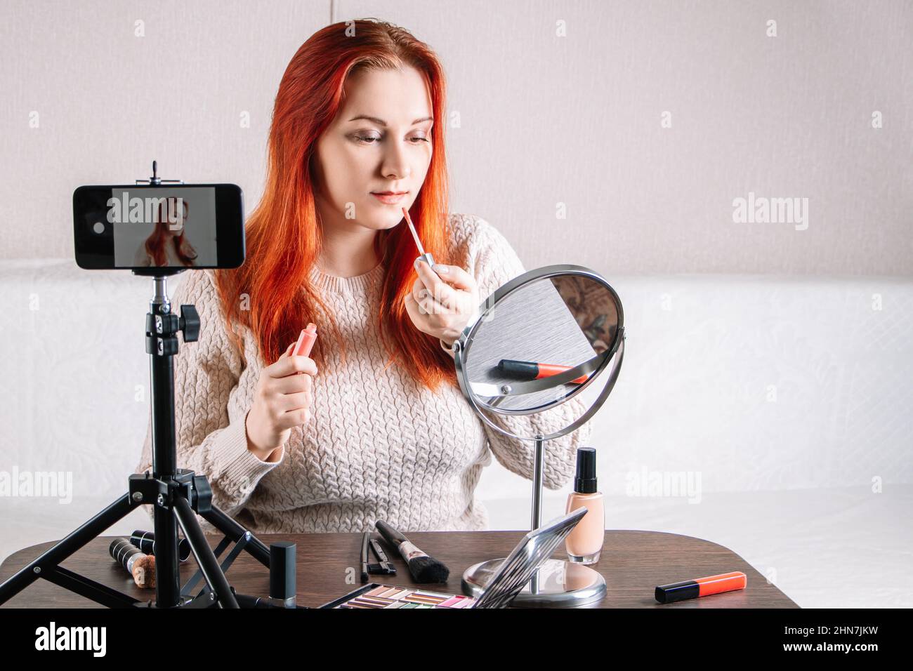 Beauty blogger influencer leads online stream. A young woman shows how ...