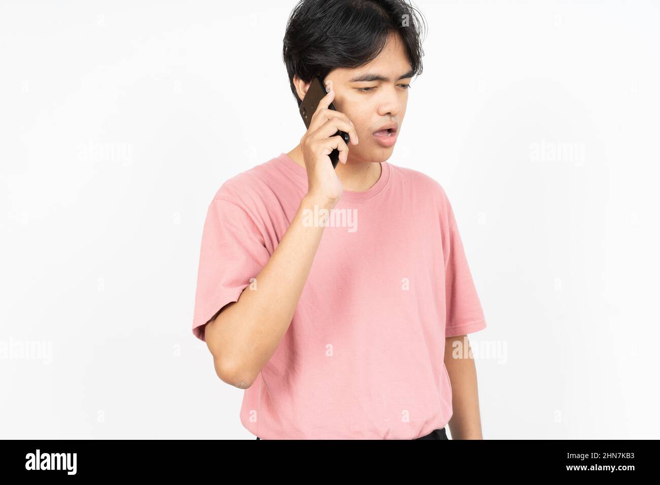 Talking on the phone with serious angry face expression of asian man ...