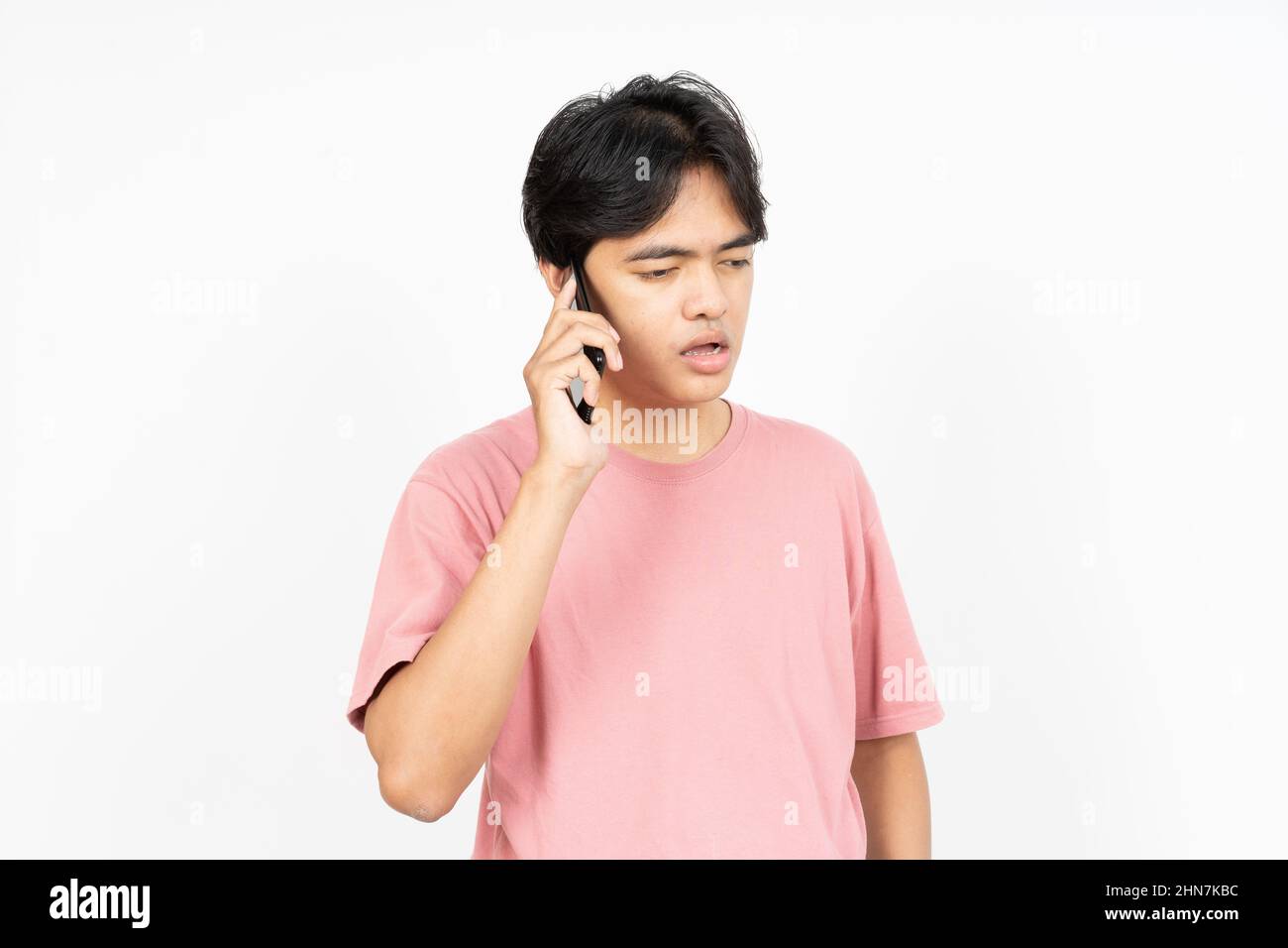 Talking on the phone with serious angry face expression of asian man ...
