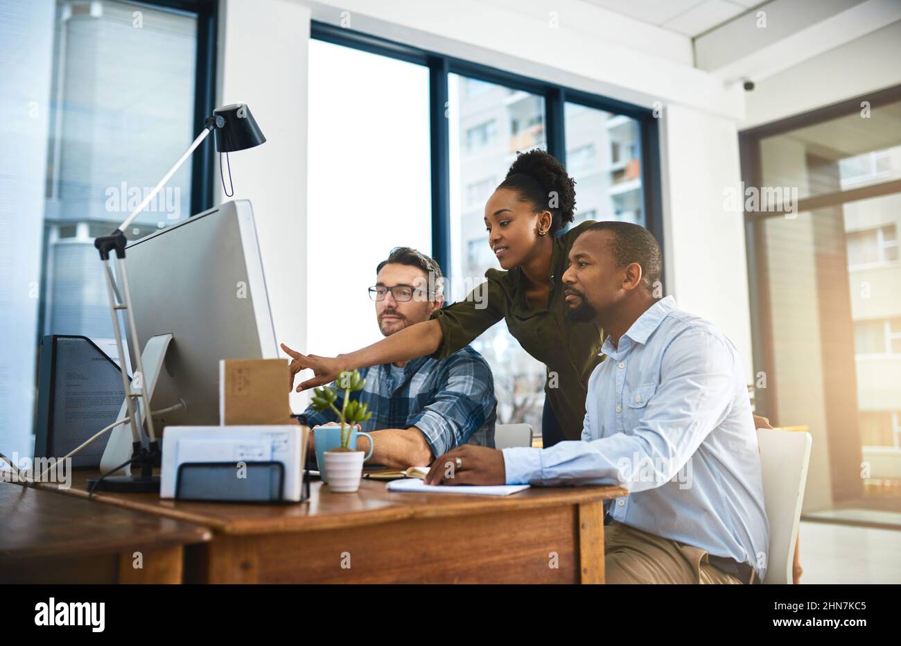 What about that. Cropped shot of three businesspeople working around a ...