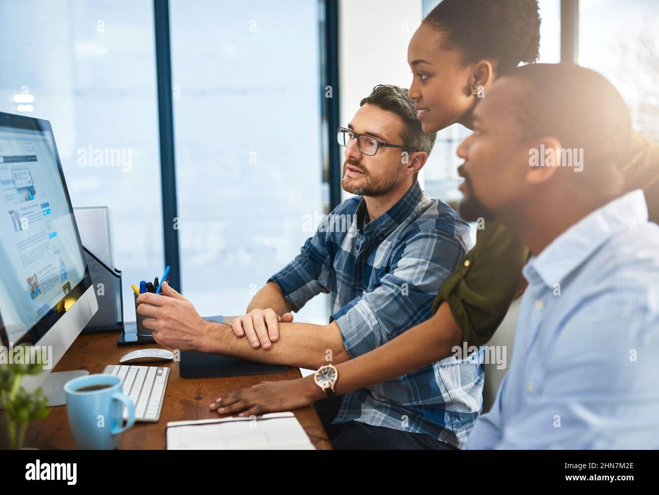 Teamwork is the key to success. Cropped shot of three businesspeople ...