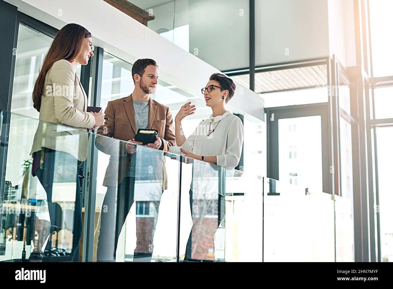 Time for a quick catch up in the office. Shot of a group of colleagues ...