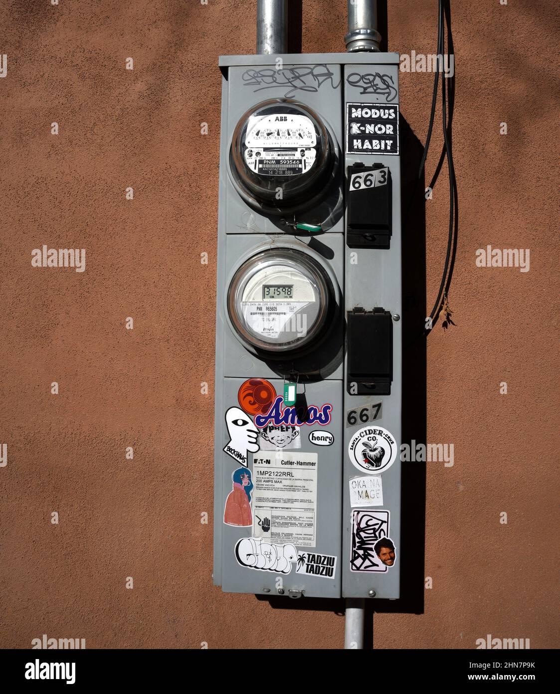 An electric meter decorated with decals along a road in Santa Fe, New ...