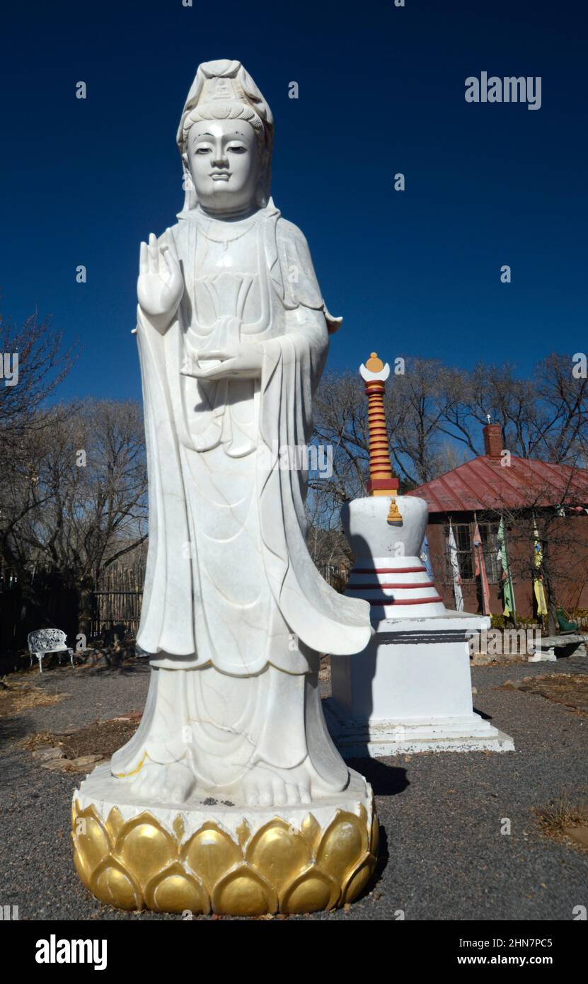 A statue of Quan Am, the bodhisattva of compassion, in front of a ...