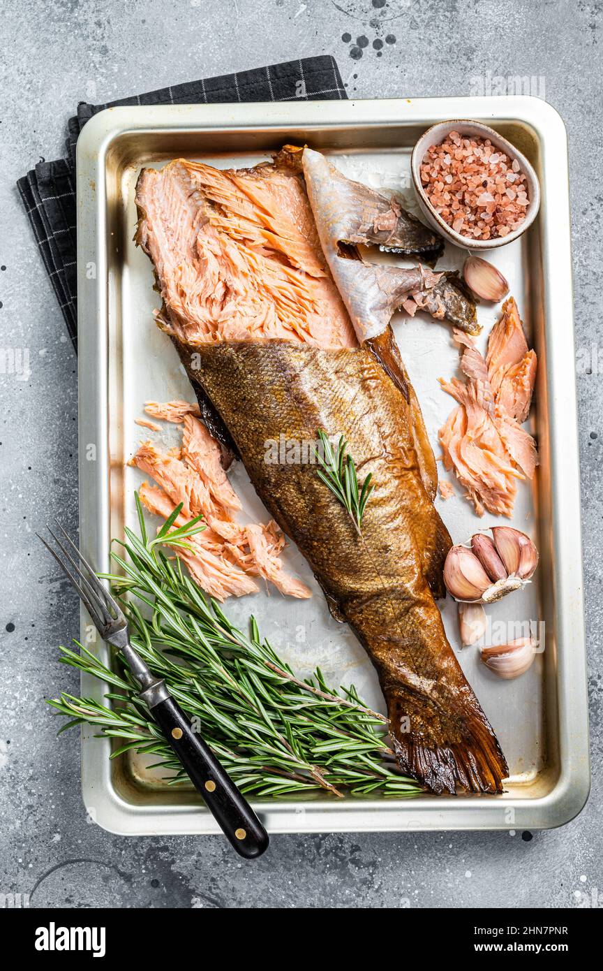 Hot smoked salmon, trout fish with herbs. Gray background. Top view ...