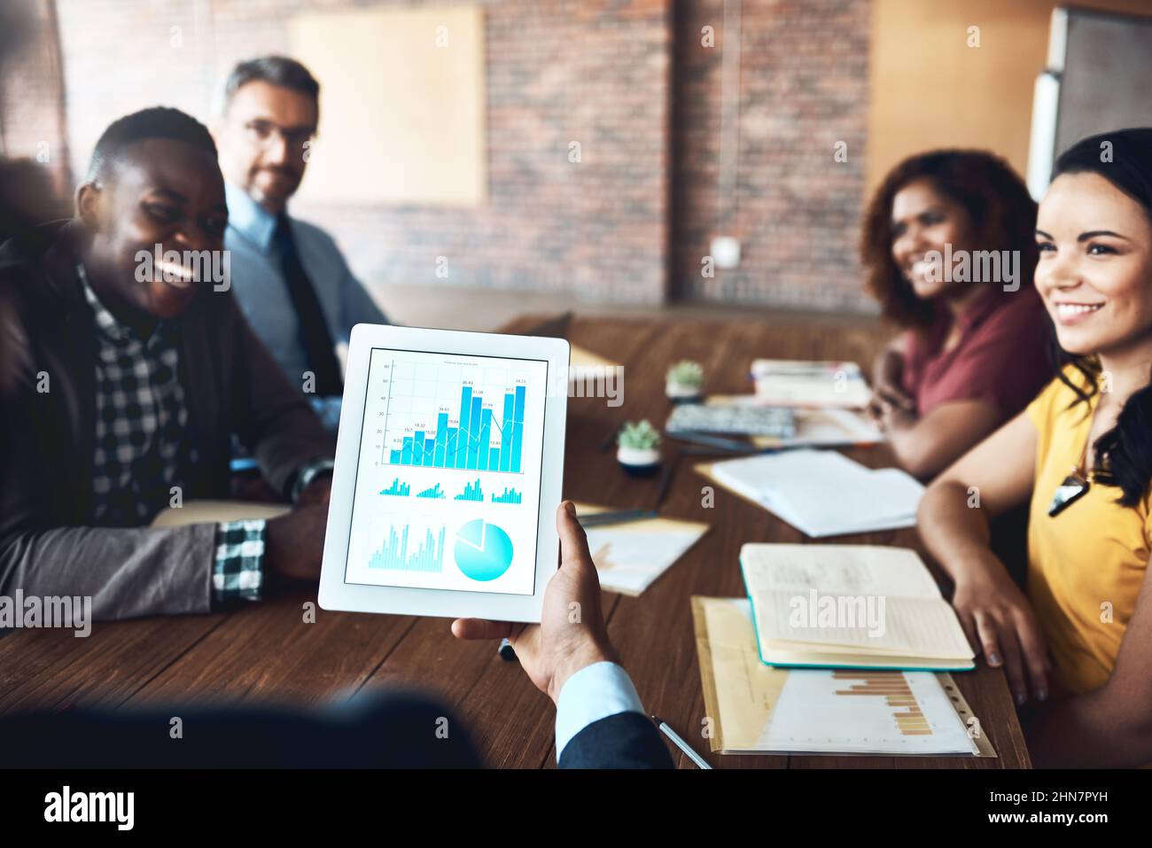 Business keeps growing through their team dedication. Shot of a group ...